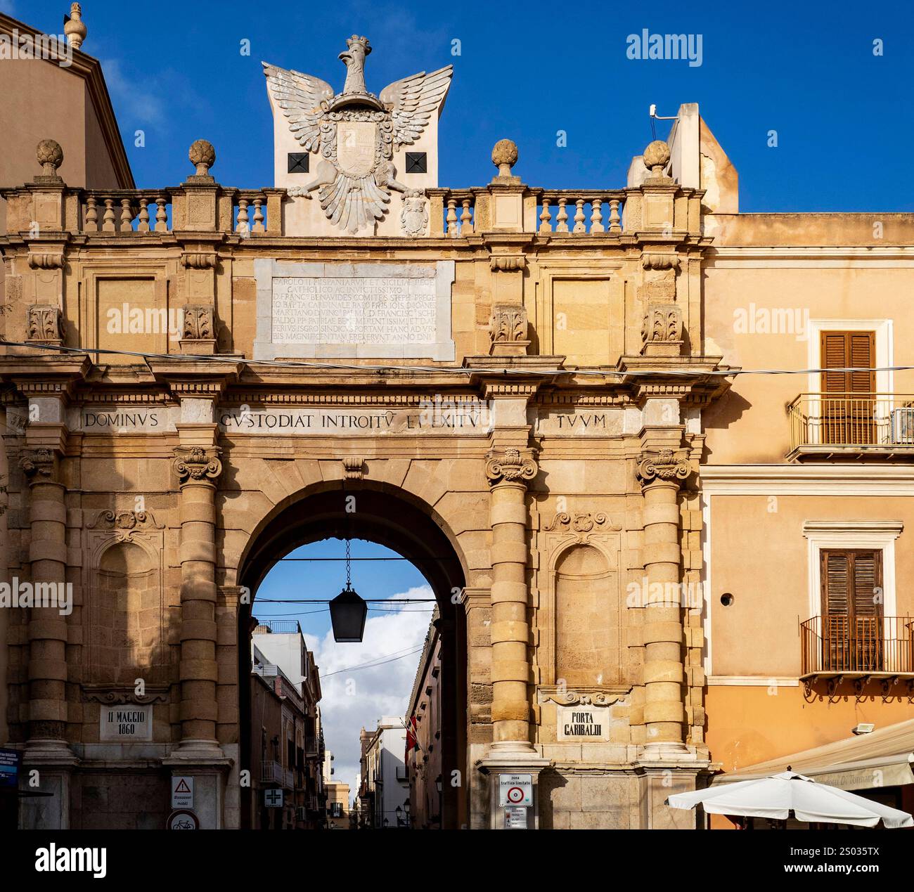 A historic archway with intricate stone carvings and a large eagle ...