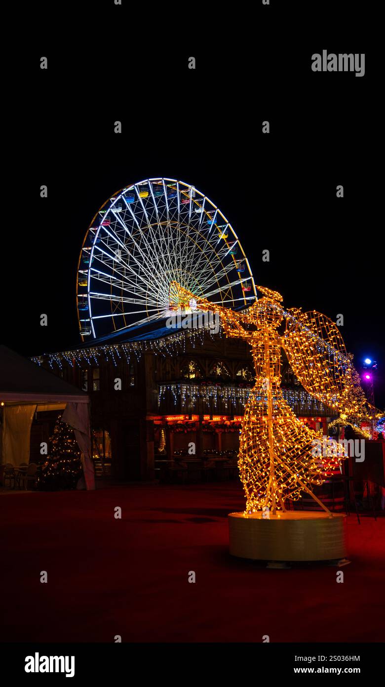 Illuminated Christmas angel made of LED lights playing a trumpet ...