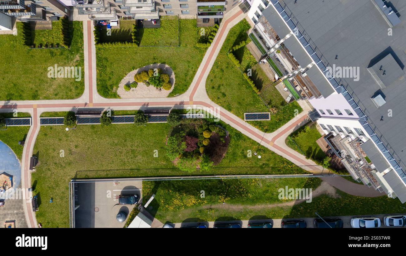 Aerial view of a landscaped area featuring green lawns, pathways, and ...