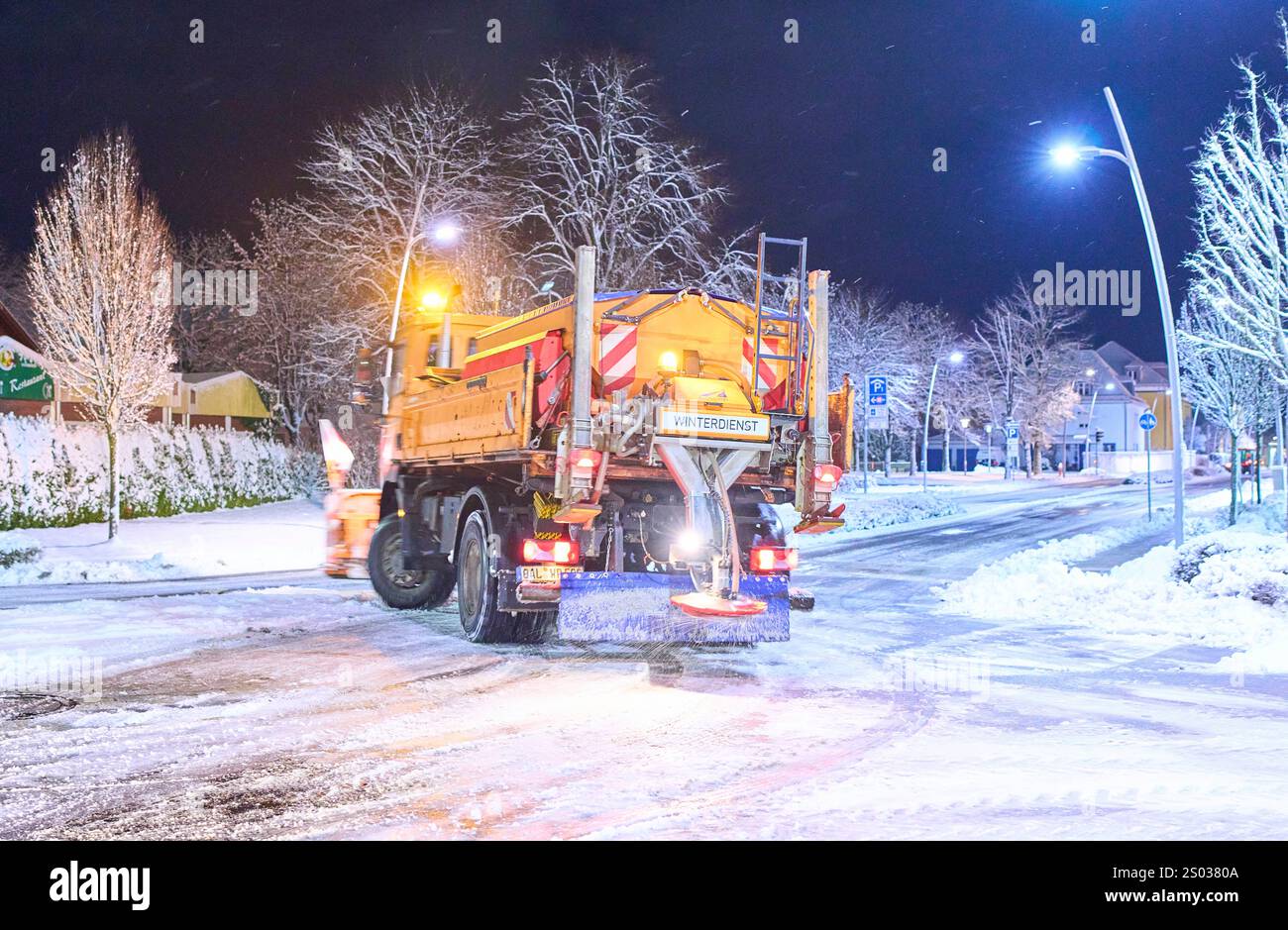 Cars and street covered by snow and snow plows try to combat the heavy ...