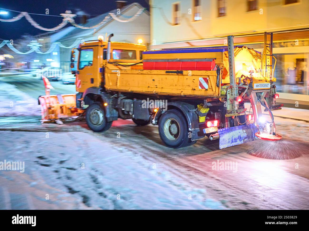 Cars covered by snow and snow plows try to combat the heavy onset of ...