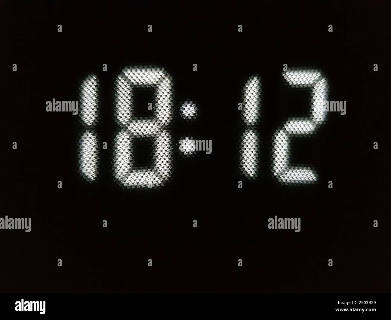 A digital clock face showing the time in white numbers on a black ...