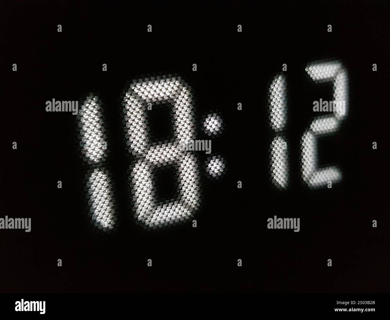 A digital clock face showing the time in white numbers on a black ...
