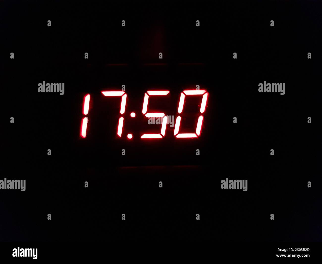 A digital clock face showing the time in white numbers on a black ...