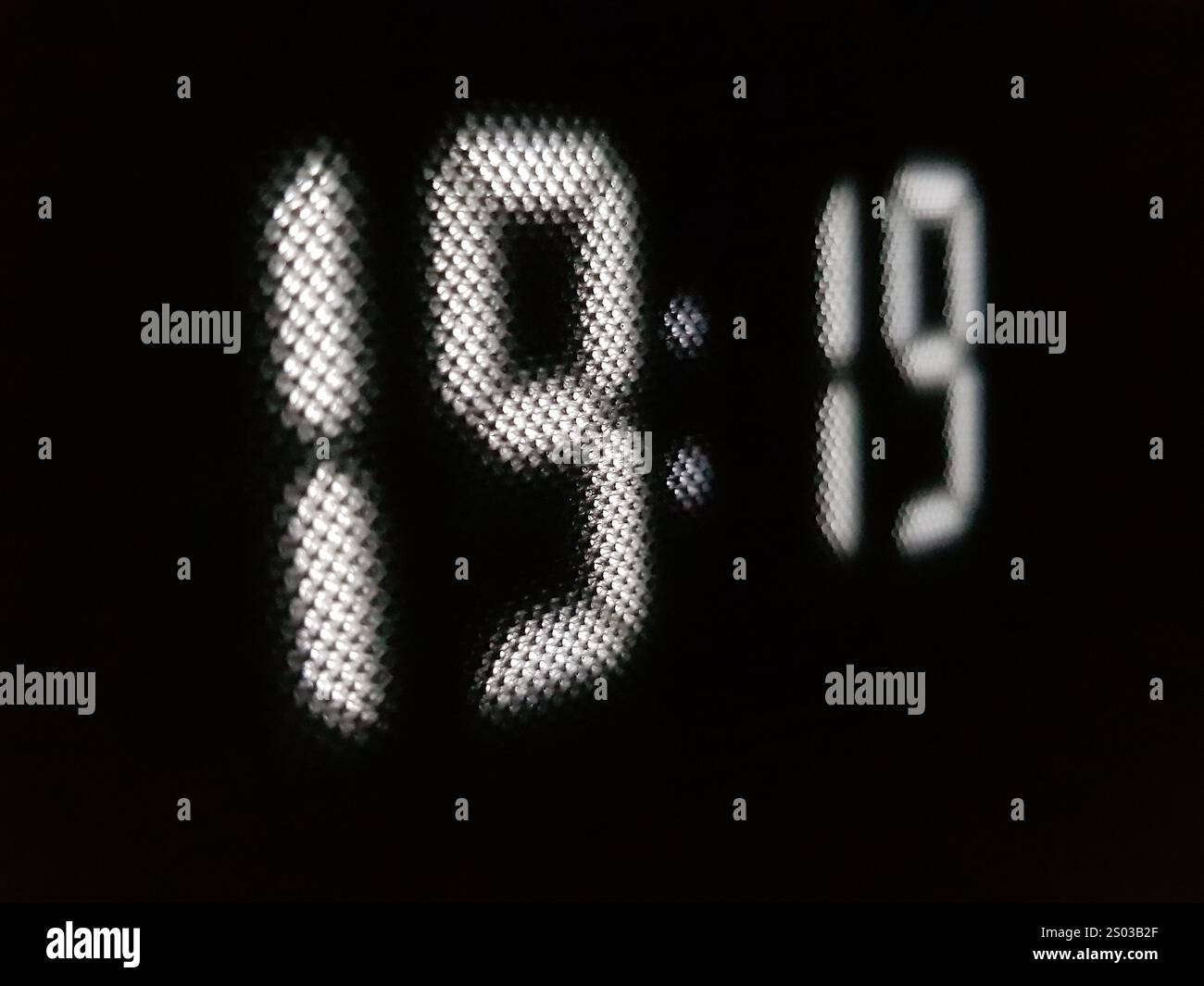A digital clock face showing the time in white numbers on a black ...
