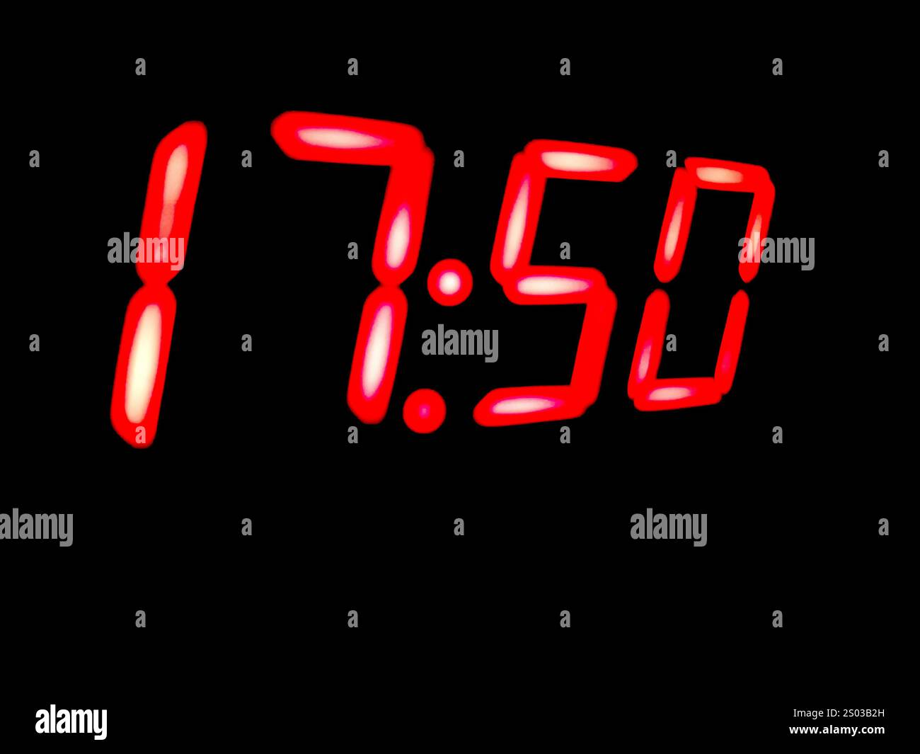 A digital clock face showing the time in red numbers on a black ...