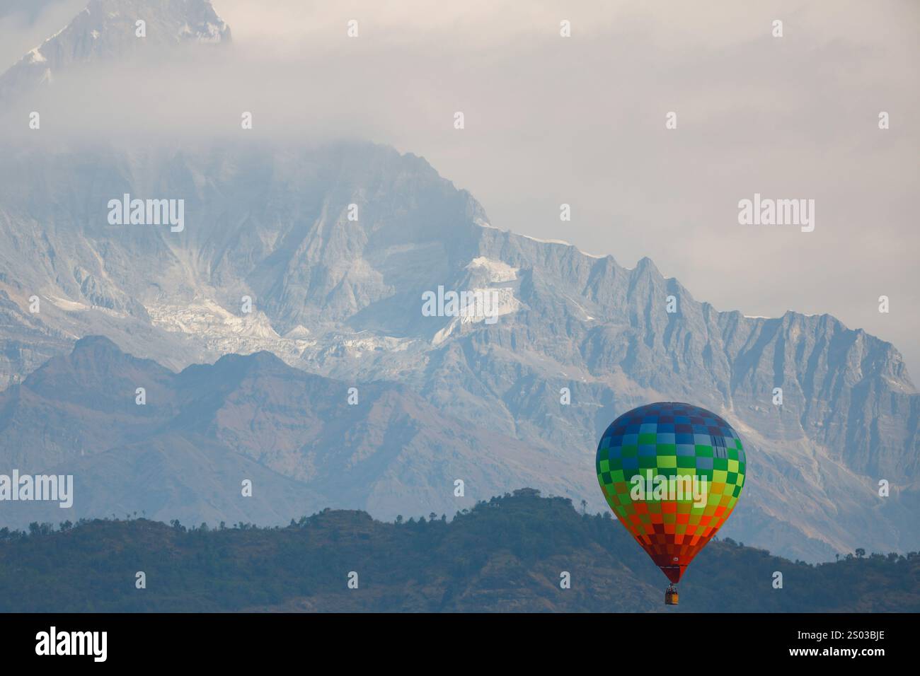 Pokhara, Nepal. 24th Dec, 2024. A hot air balloon soars against the ...