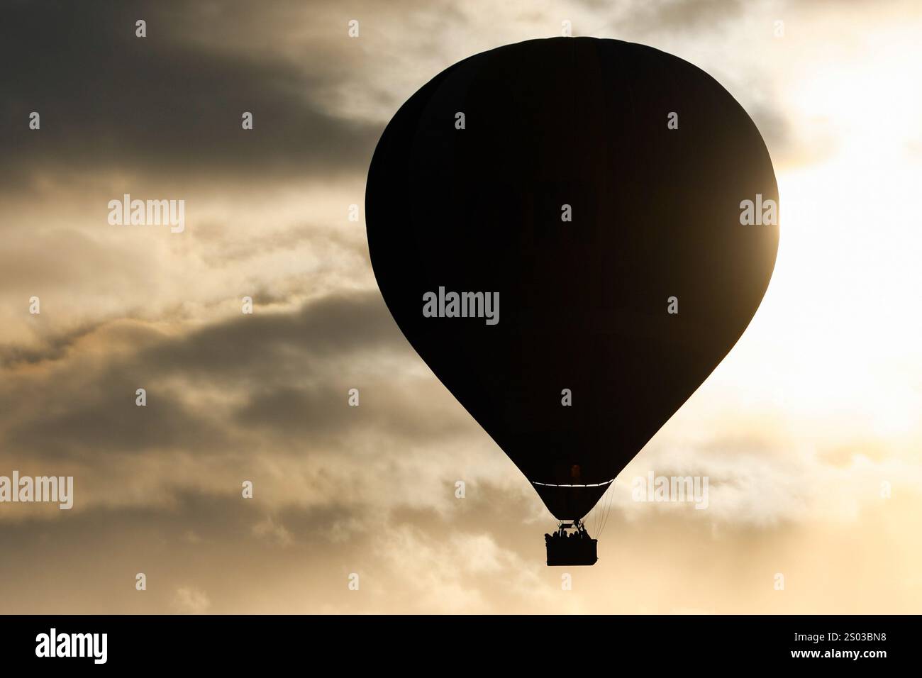 Pokhara, Nepal. 24th Dec, 2024. A hot air balloon soars against the sun ...