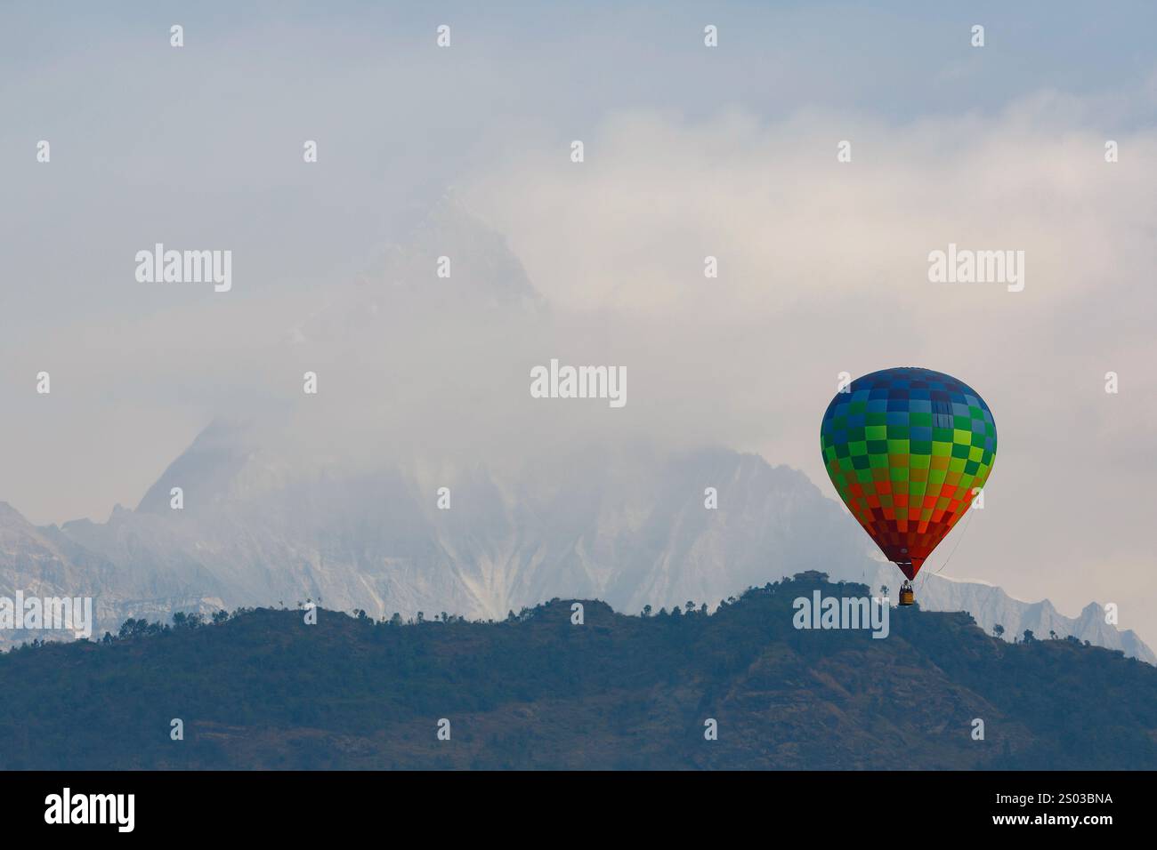 Pokhara, Nepal. 24th Dec, 2024. A hot air balloon soars against the ...