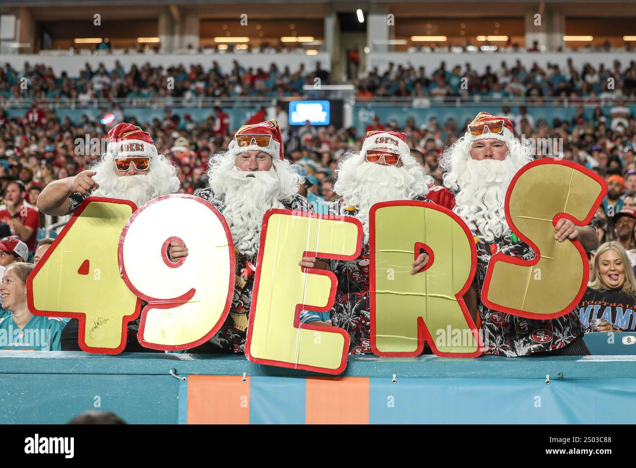 Miami Gardens, FL USA; San Francisco 49ers fans dressed as Santas cheer ...