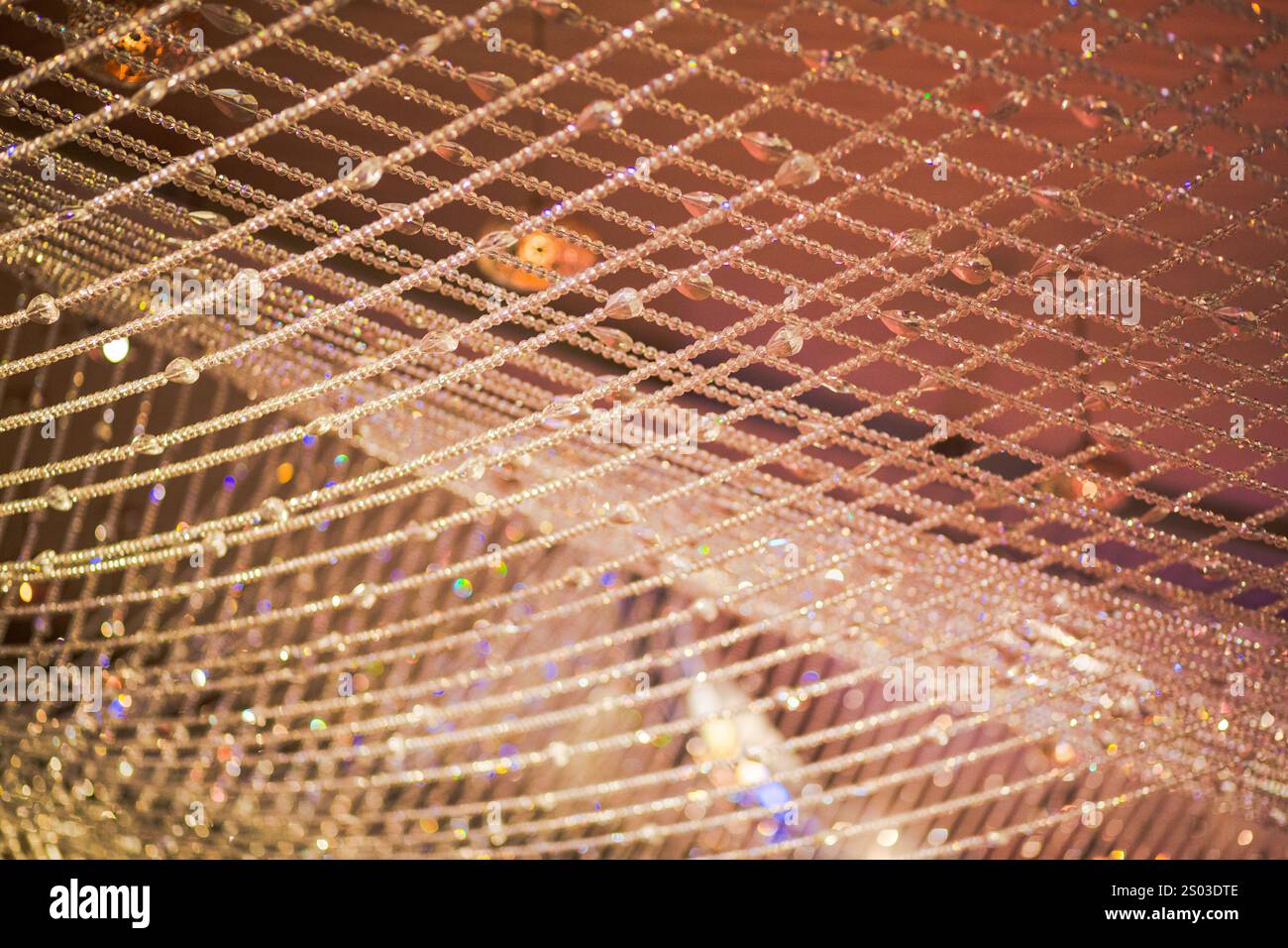 A gold and silver stringed object with many small beads. The beads are ...