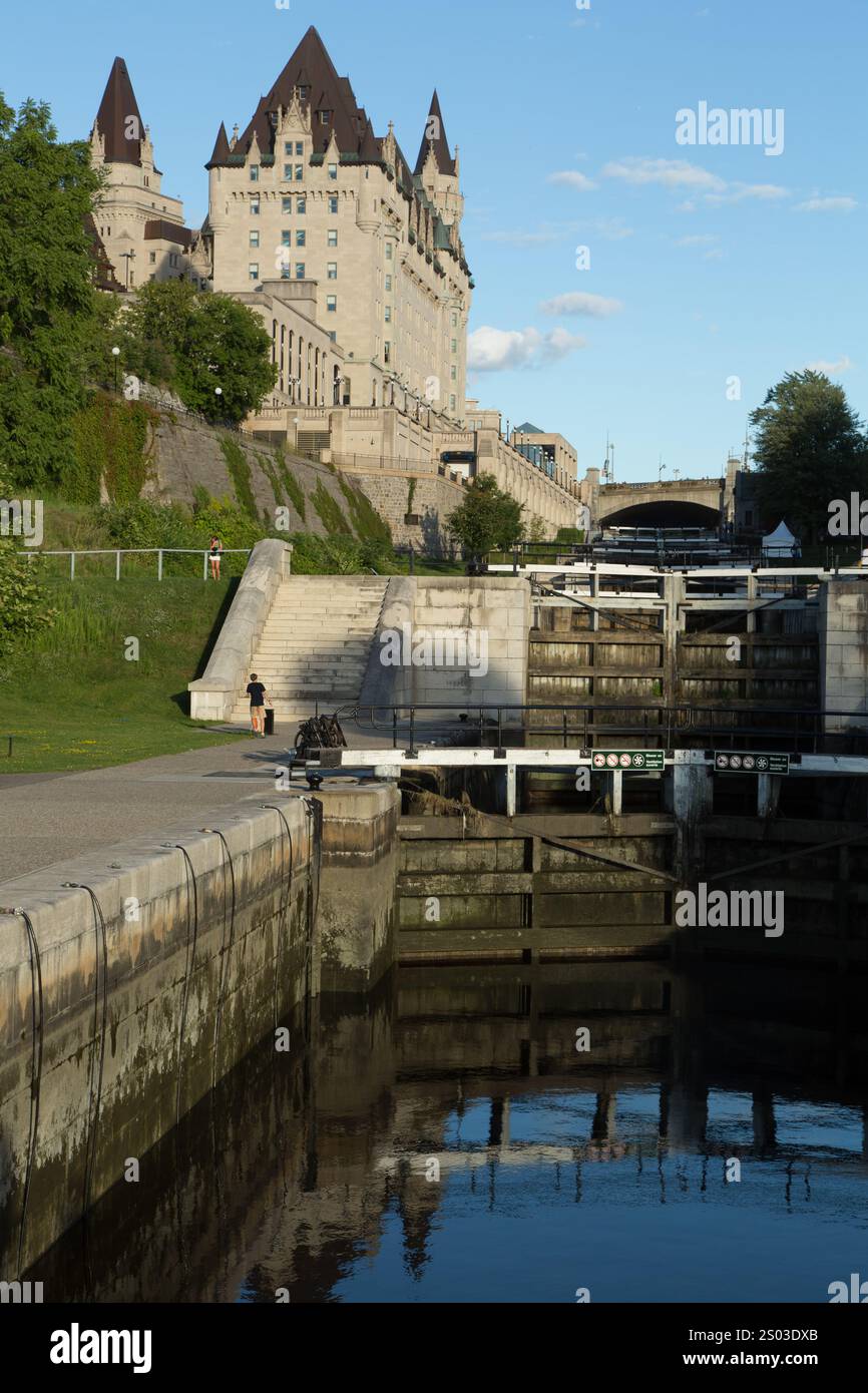 A castle with a large gate and a bridge. The castle is on a hill and ...