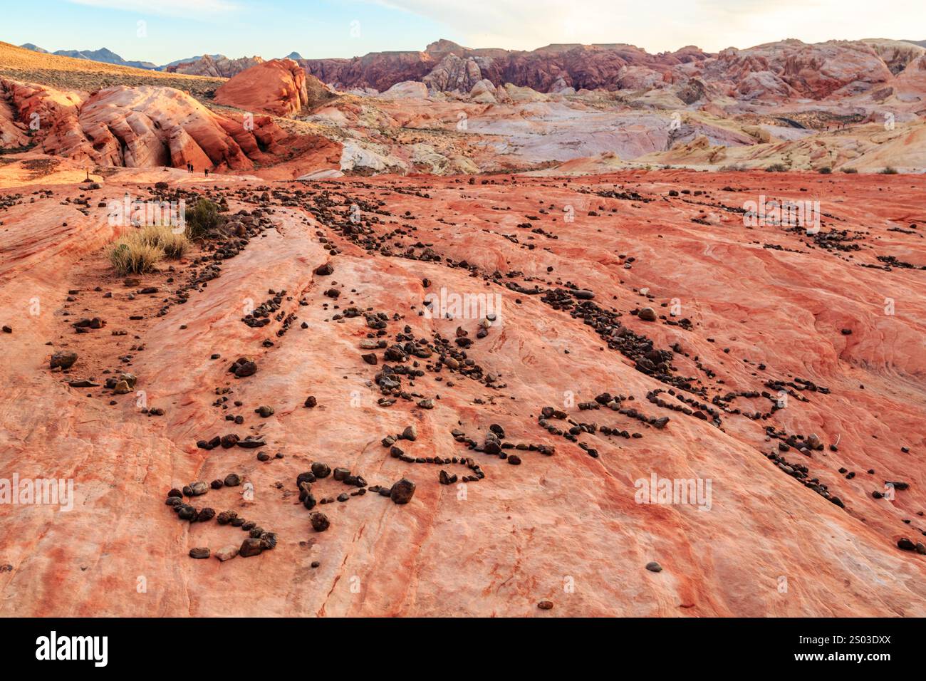 A rocky desert landscape with the word "sacrifice" written in rocks ...