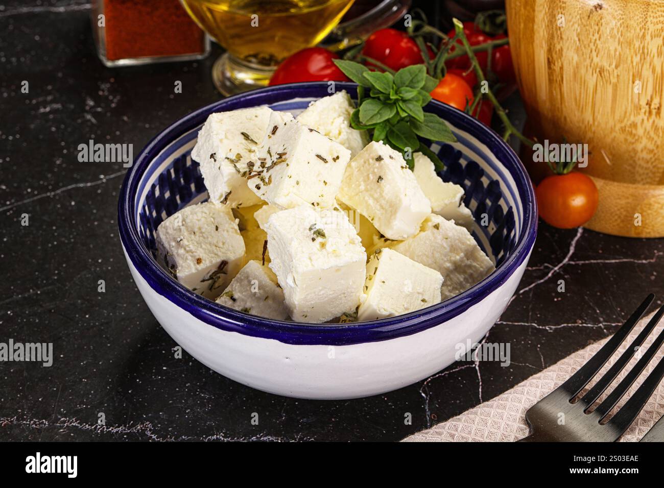 Greek traditional Feta cheese cubes with herbs and spices Stock Photo ...