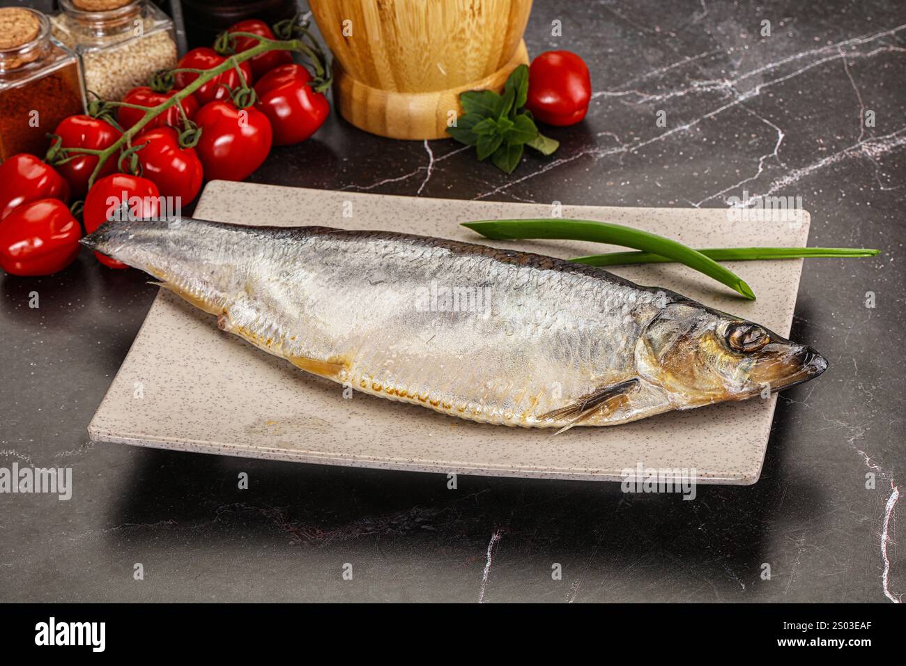 Whole raw salted herring fish in the plate Stock Photo - Alamy