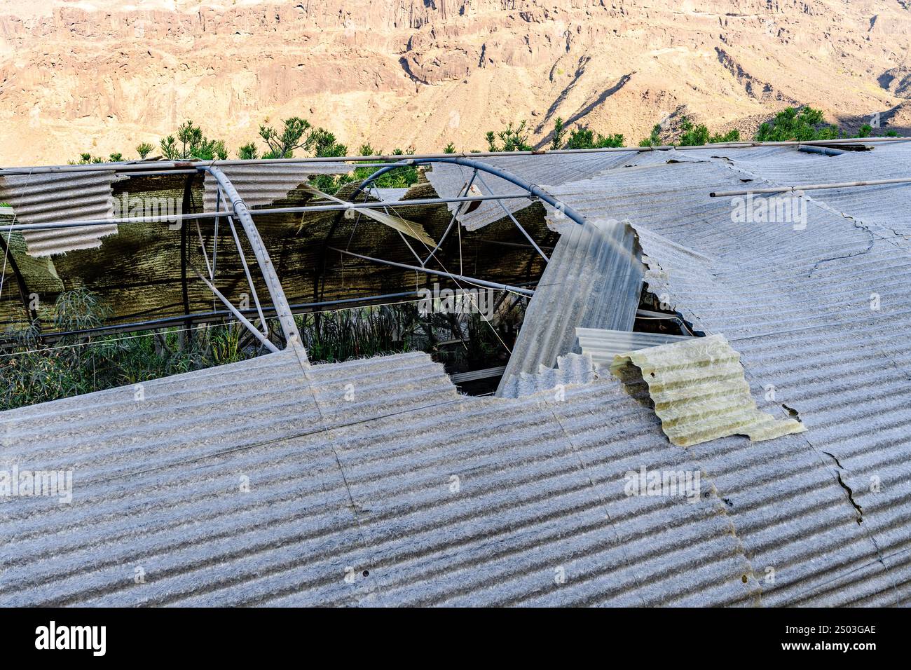 A roof with a hole in it and a piece of tape on it. The roof is old and ...