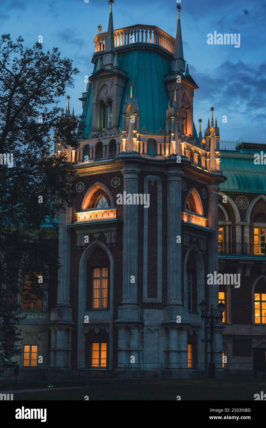 Illuminated Gothic tower with arched windows at dusk Stock Photo - Alamy