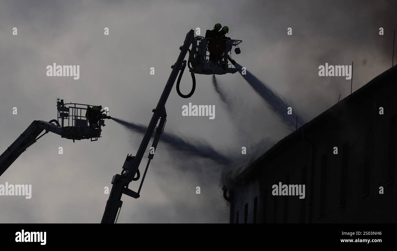 Firefighters fight with the fire of plastic sawdust in industrial ...