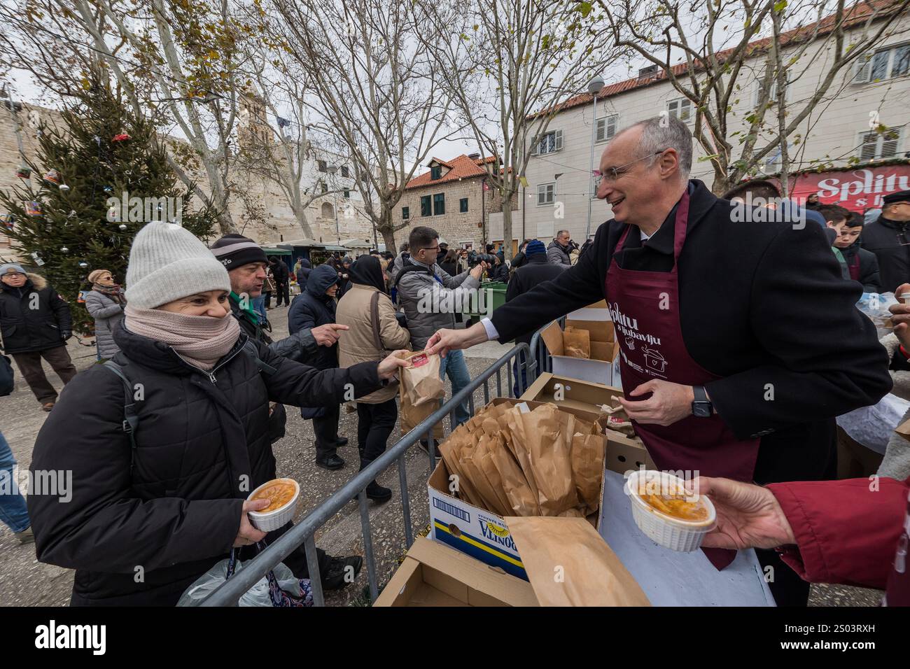 Split, Croatia. 24th Dec, 2024. Mayor of Split Ivica Puljak servers a ...