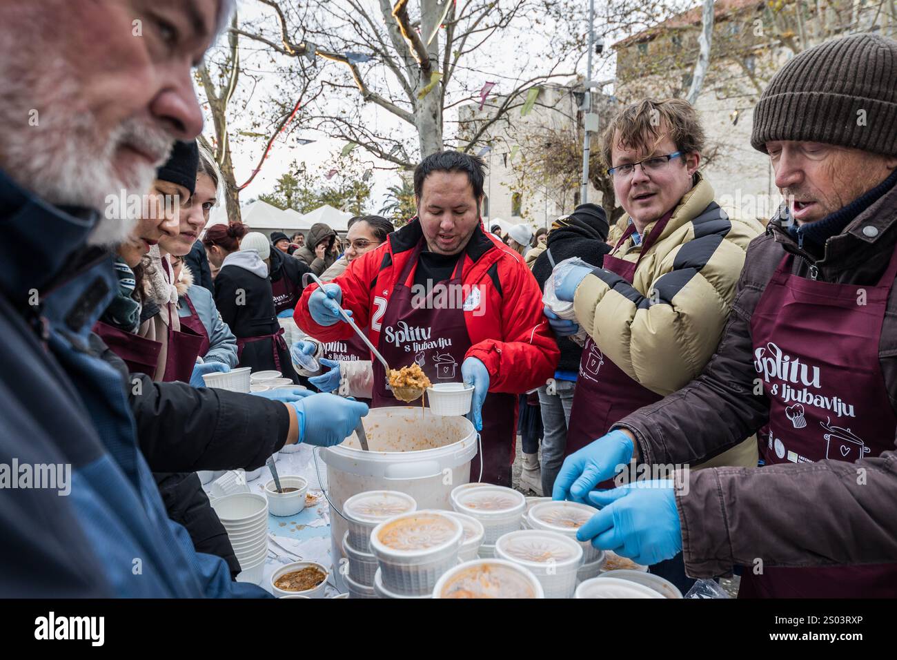 Split, Croatia. 24th Dec, 2024. Volunteers servers a free cod fish stew ...