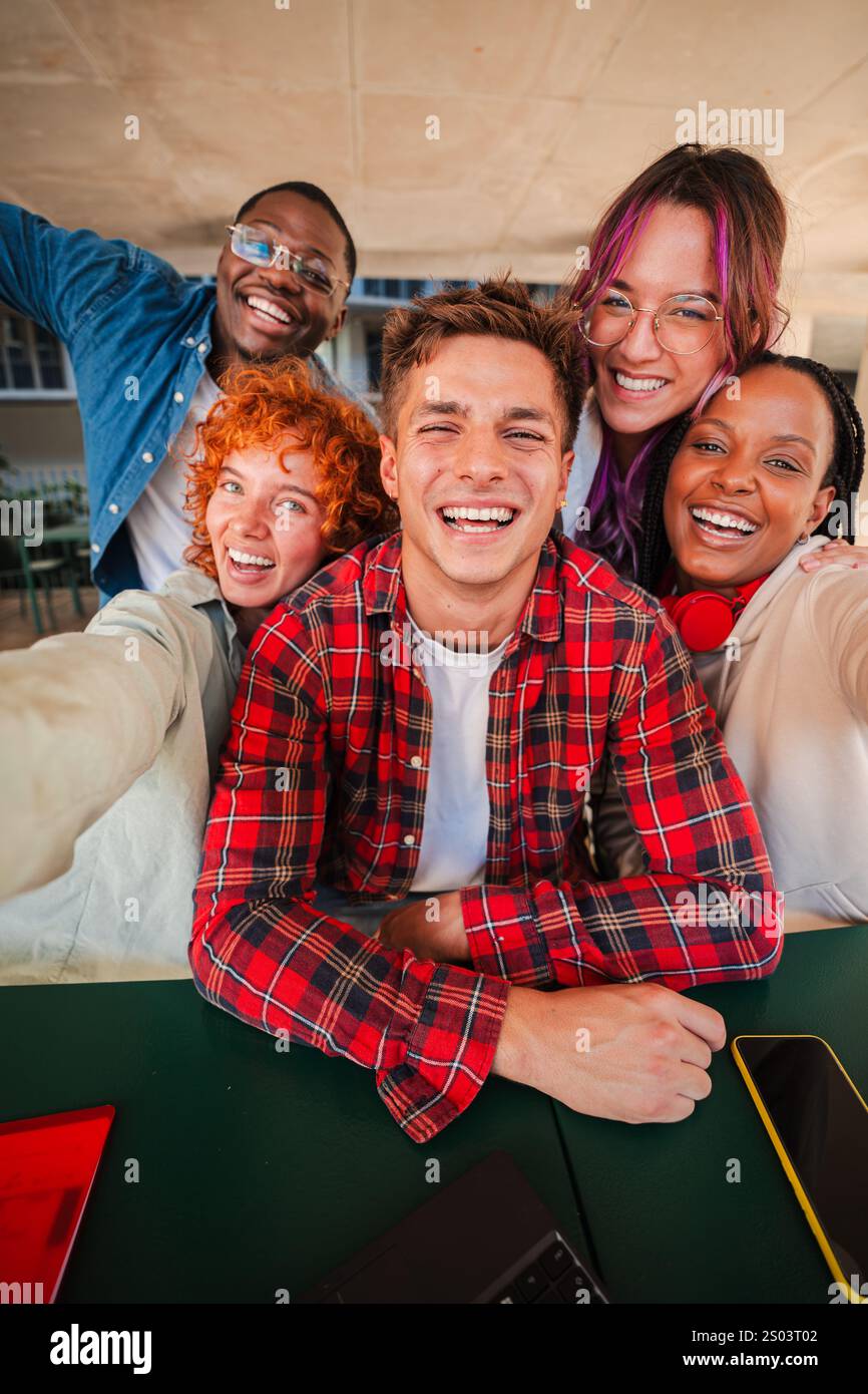 Vertical. cheerful group of diverse teenage students taking a selfie ...
