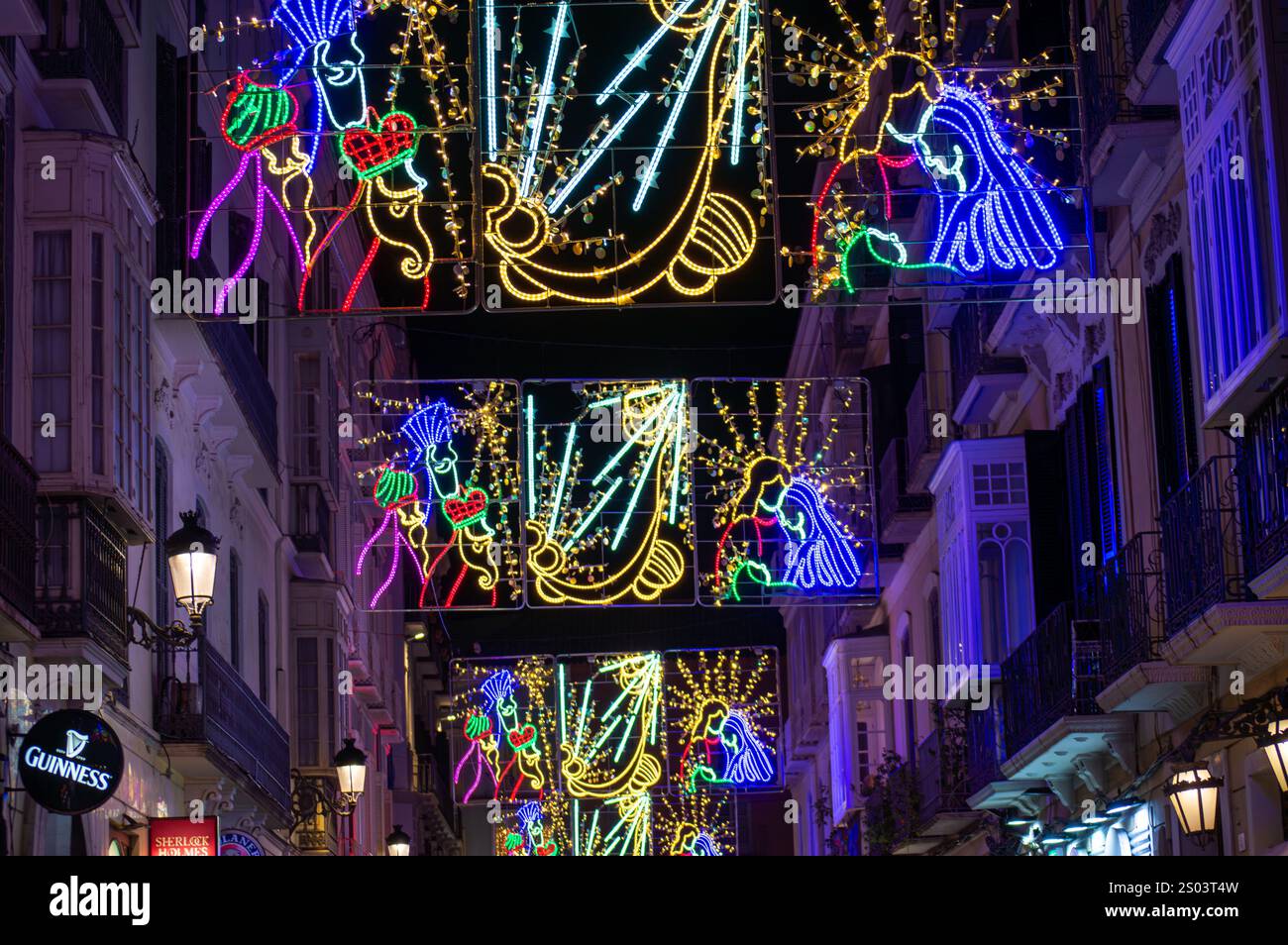 MALAGA, SPAIN - DECEMBER 21, 2024: The city center glows with ...