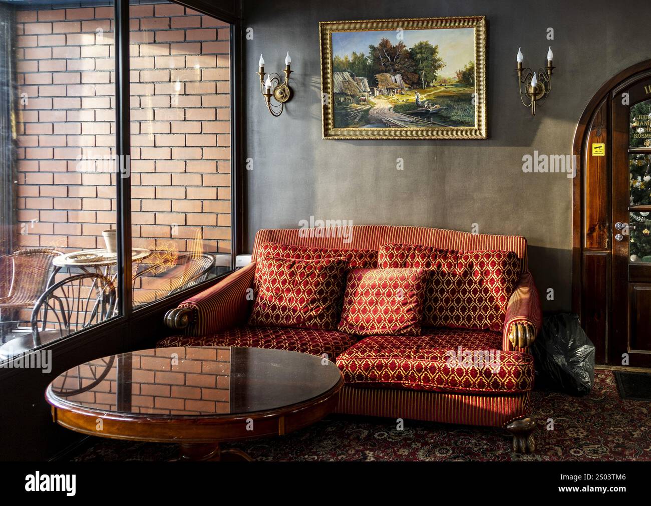 A cozy interior featuring a vintage red sofa with decorative cushions ...