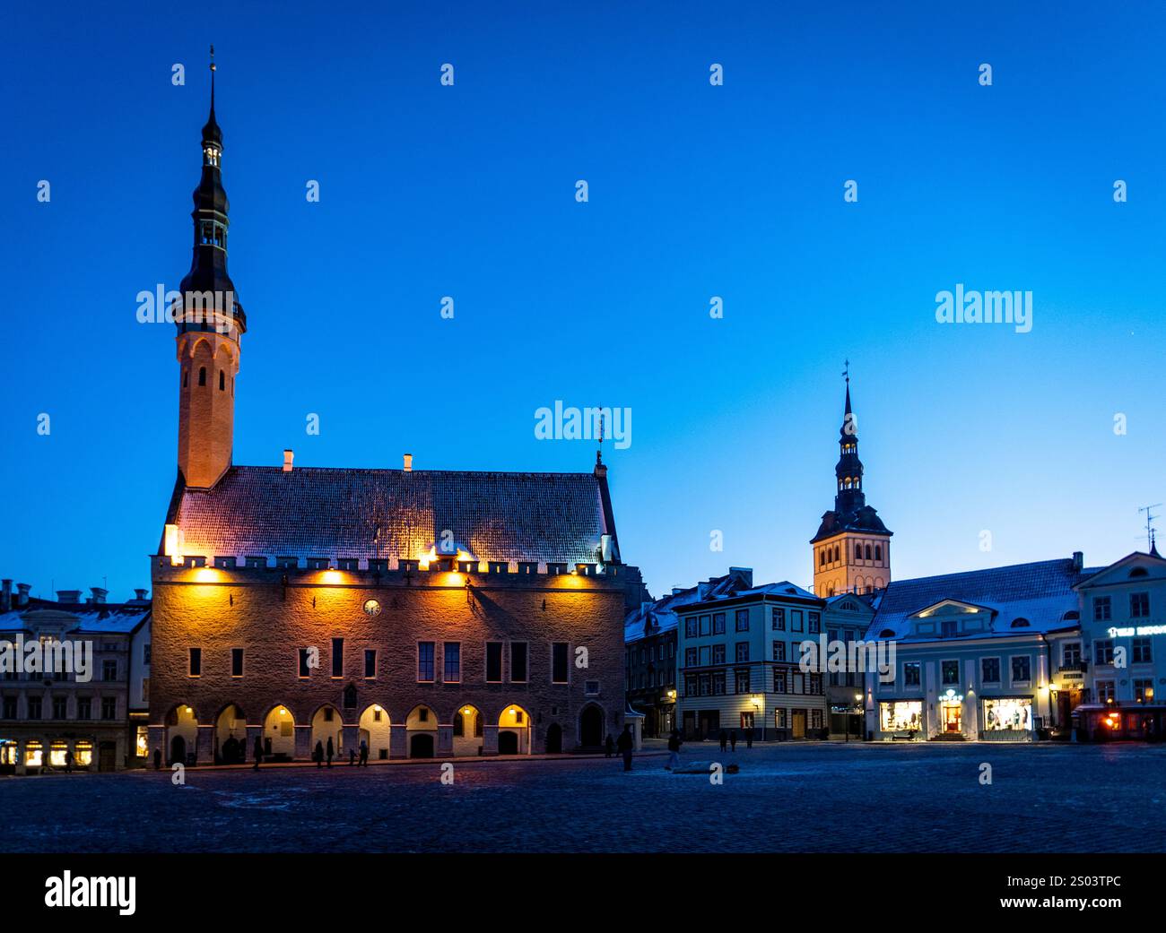 A picturesque view of a historic town square at dusk, featuring ...
