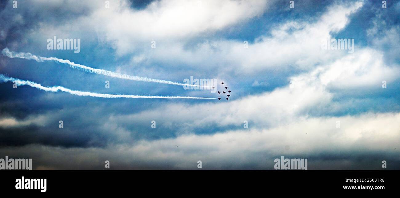 Aerial display featuring multiple jets performing synchronized ...