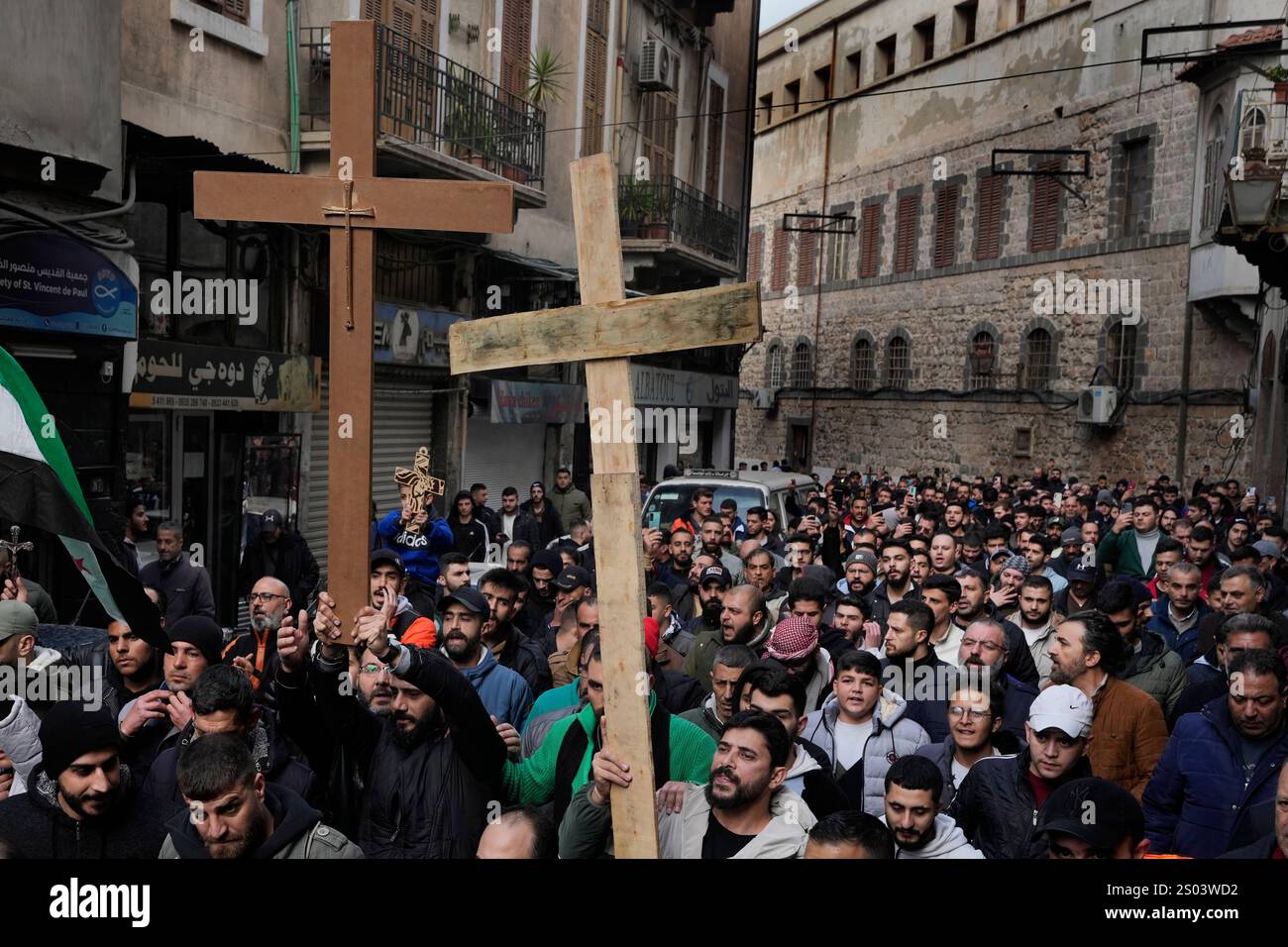 Syrian Christians hold crosses and shout slogans, as they march during ...