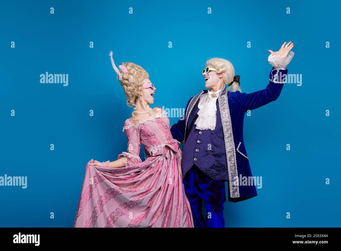 A joyful couple in elegant baroque costumes, captured against a vibrant ...