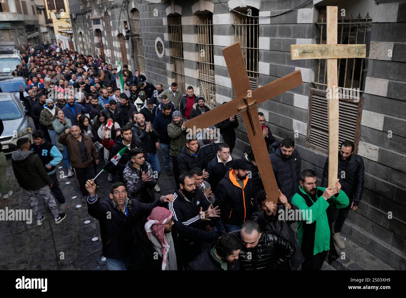 Syrian Christians carry crosses and shout slogans in Damascus, Syria ...