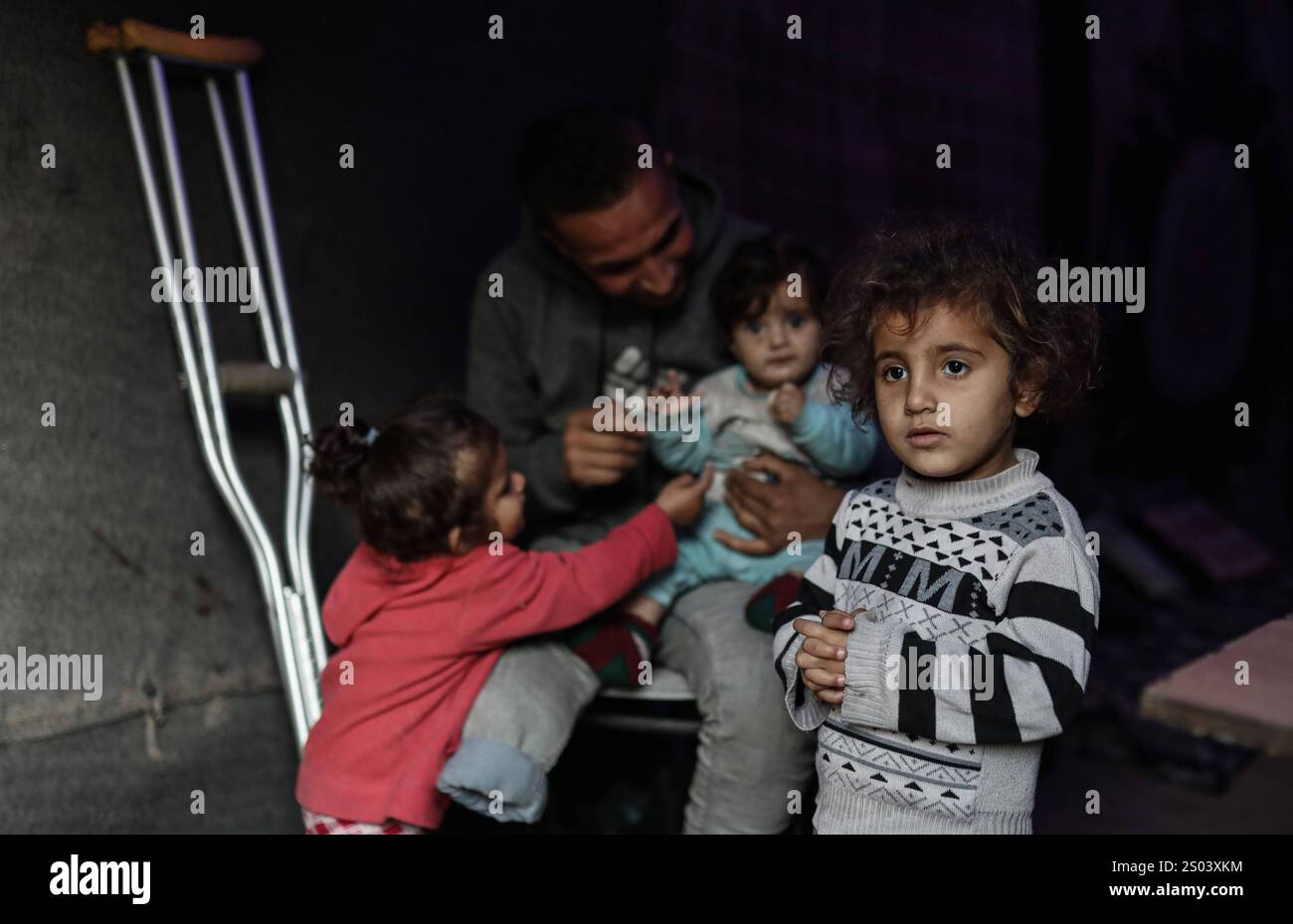 Palestinian displaced person Riyad Abu Sharkh, 26 years old, sits with ...