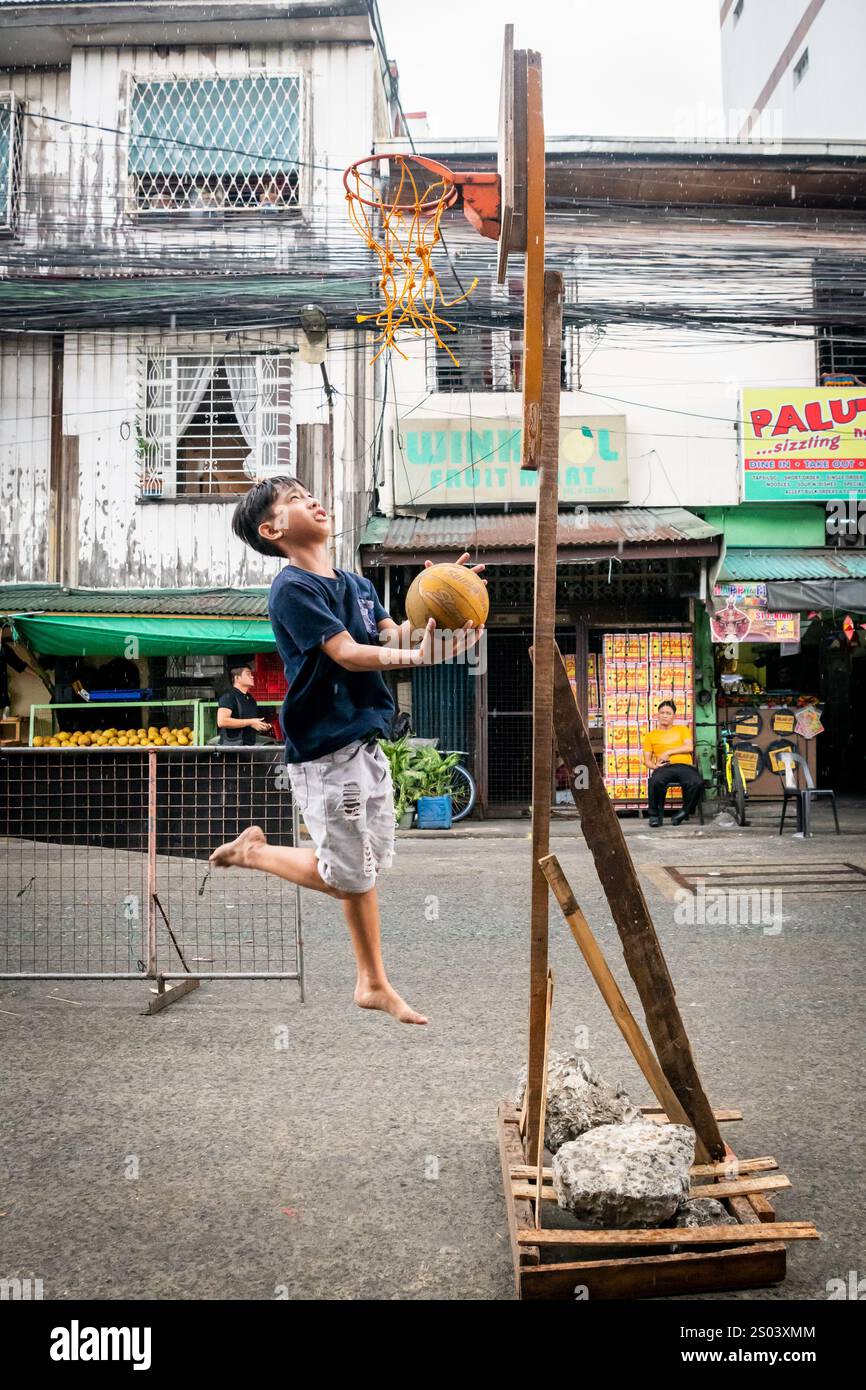 Young Filipino boys play basketball on Asuncion St. Tondo, Manila The ...