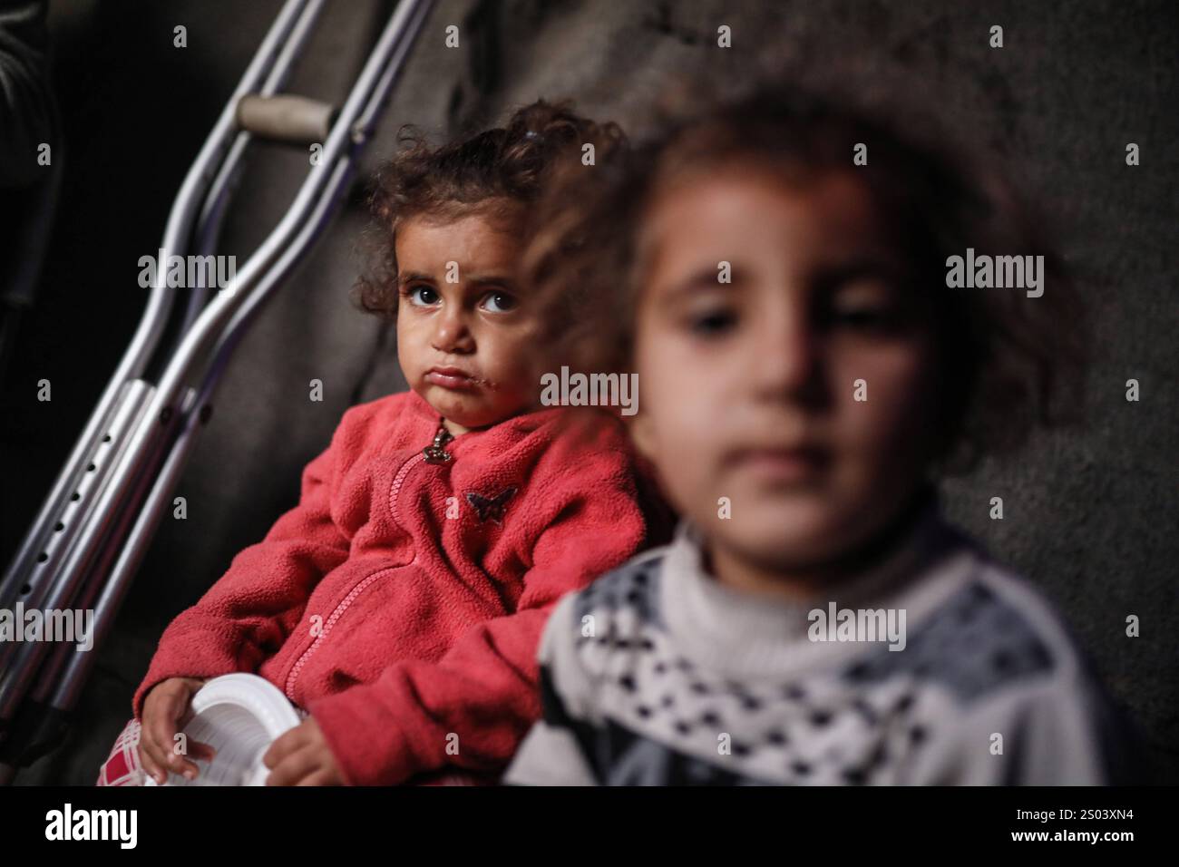 Palestinian displaced person Riyad Abu Sharkh, 26 years old, sits with ...