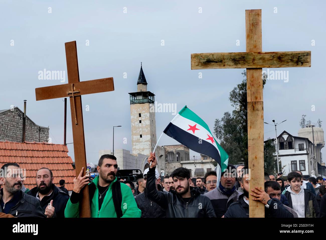Syrian Christians carry crosses and shout slogans, as they march during ...
