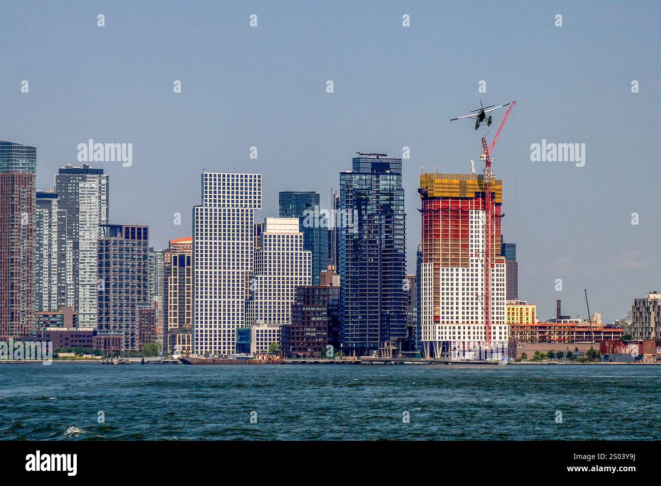 hydroplane plane flying on new york manhattan view from East river boat ...