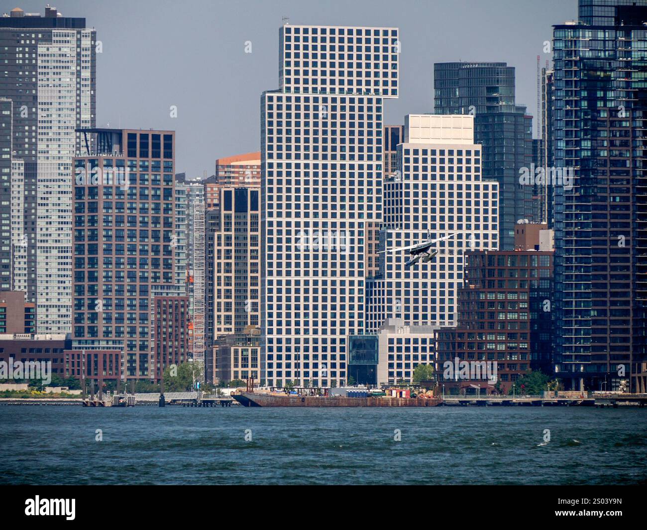 hydroplane plane flying on new york manhattan view from East river boat ...