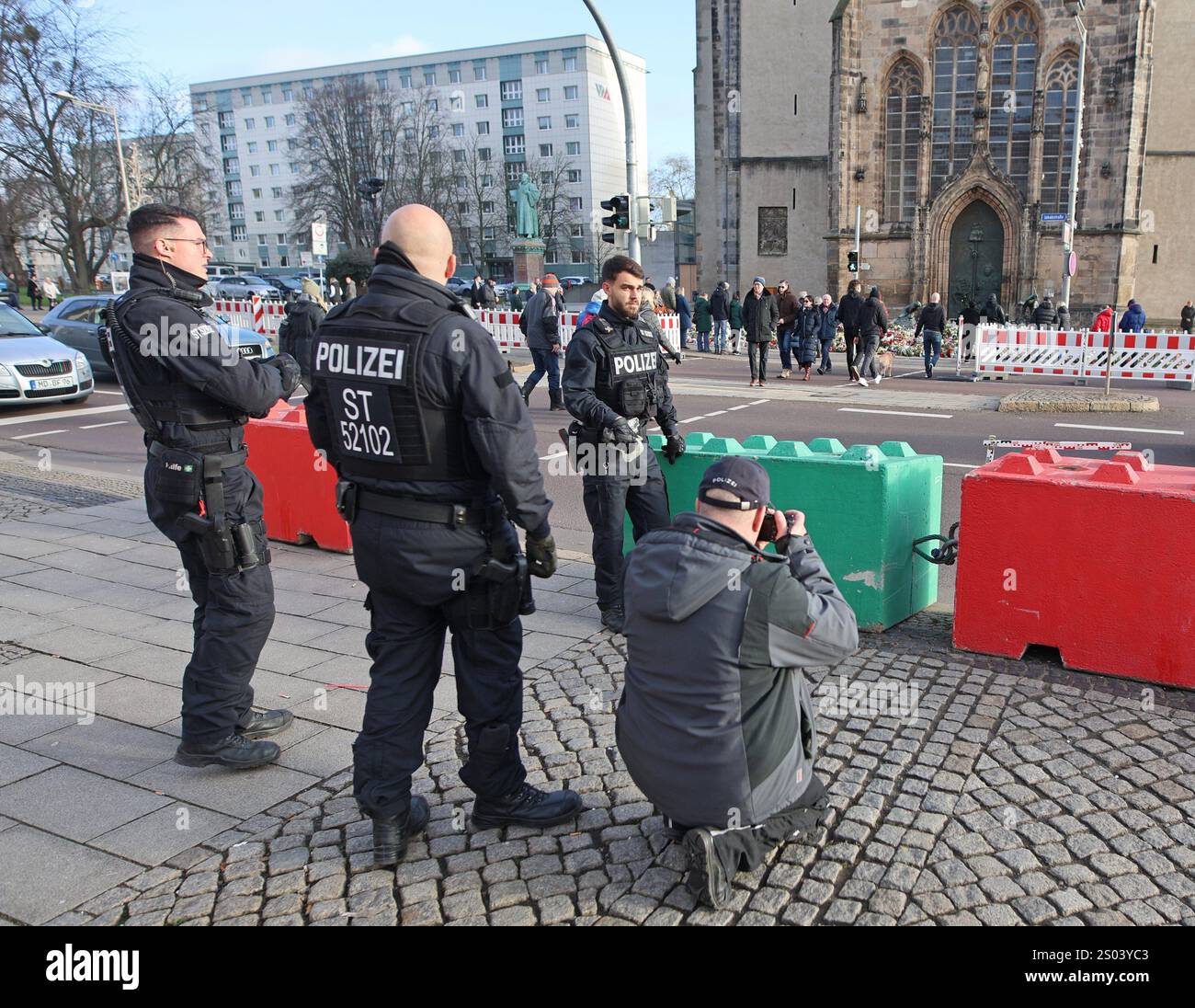Magdeburg, Germany. 24th Dec, 2024. Police officers stand in front of ...