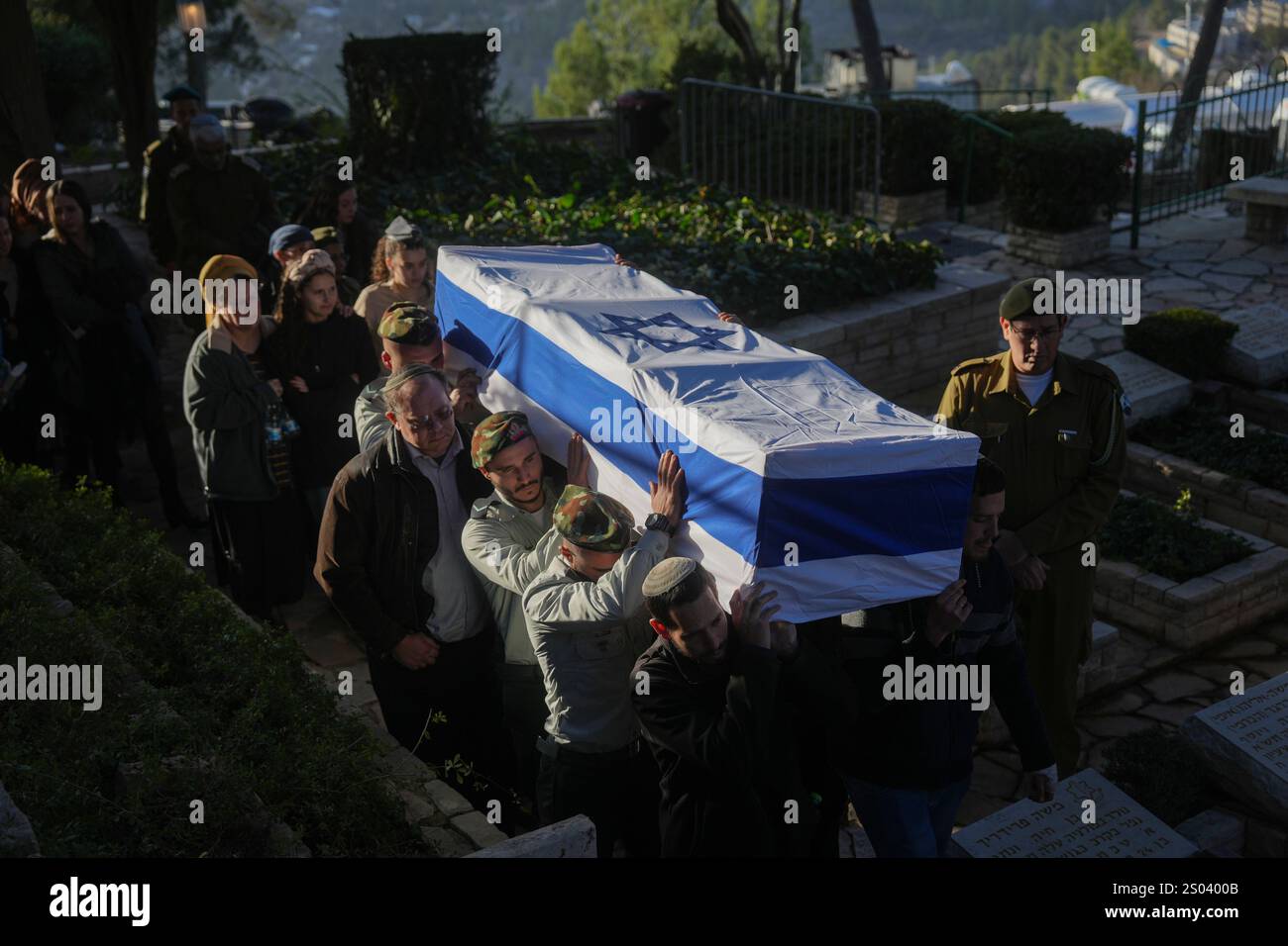 Israeli soldiers and relatives carry the flag-draped casket of 1st Sgt ...