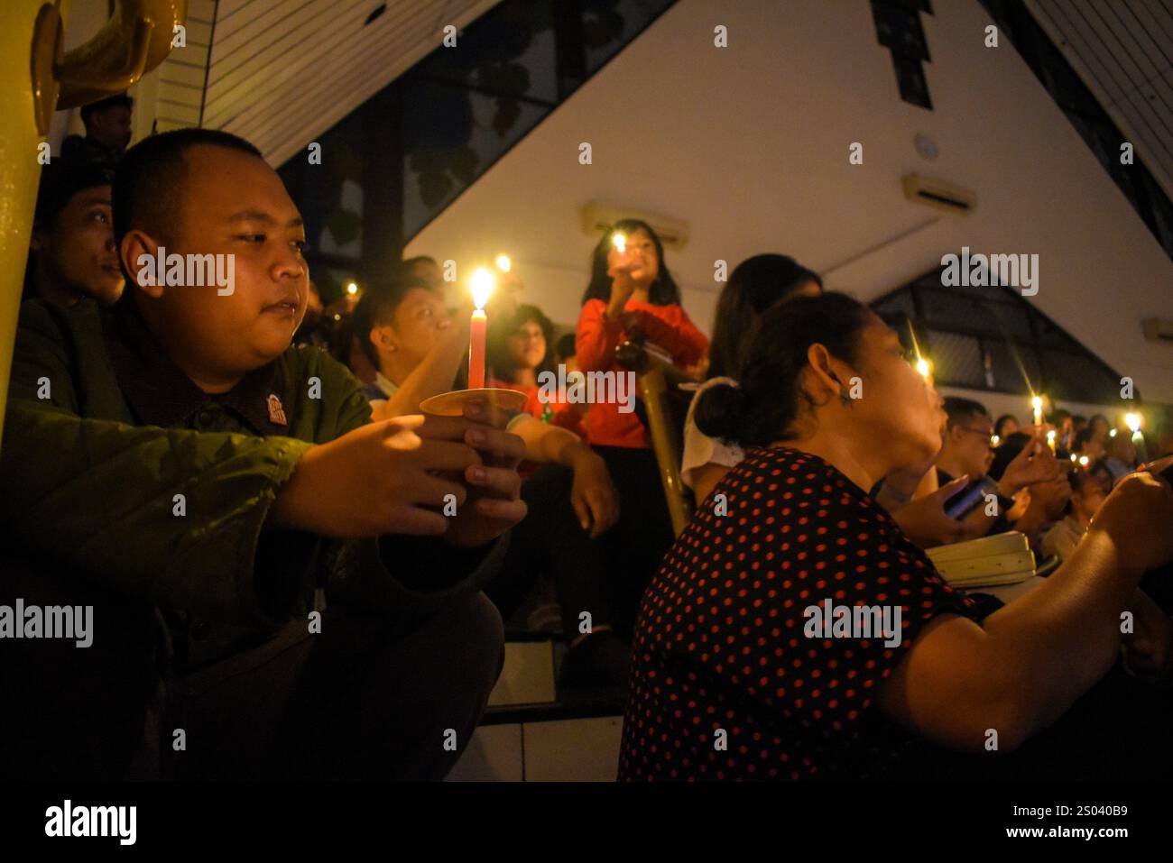 Bandung, West Java, Indonesia. 24th Dec, 2024. Indonesian christians light candles during ...