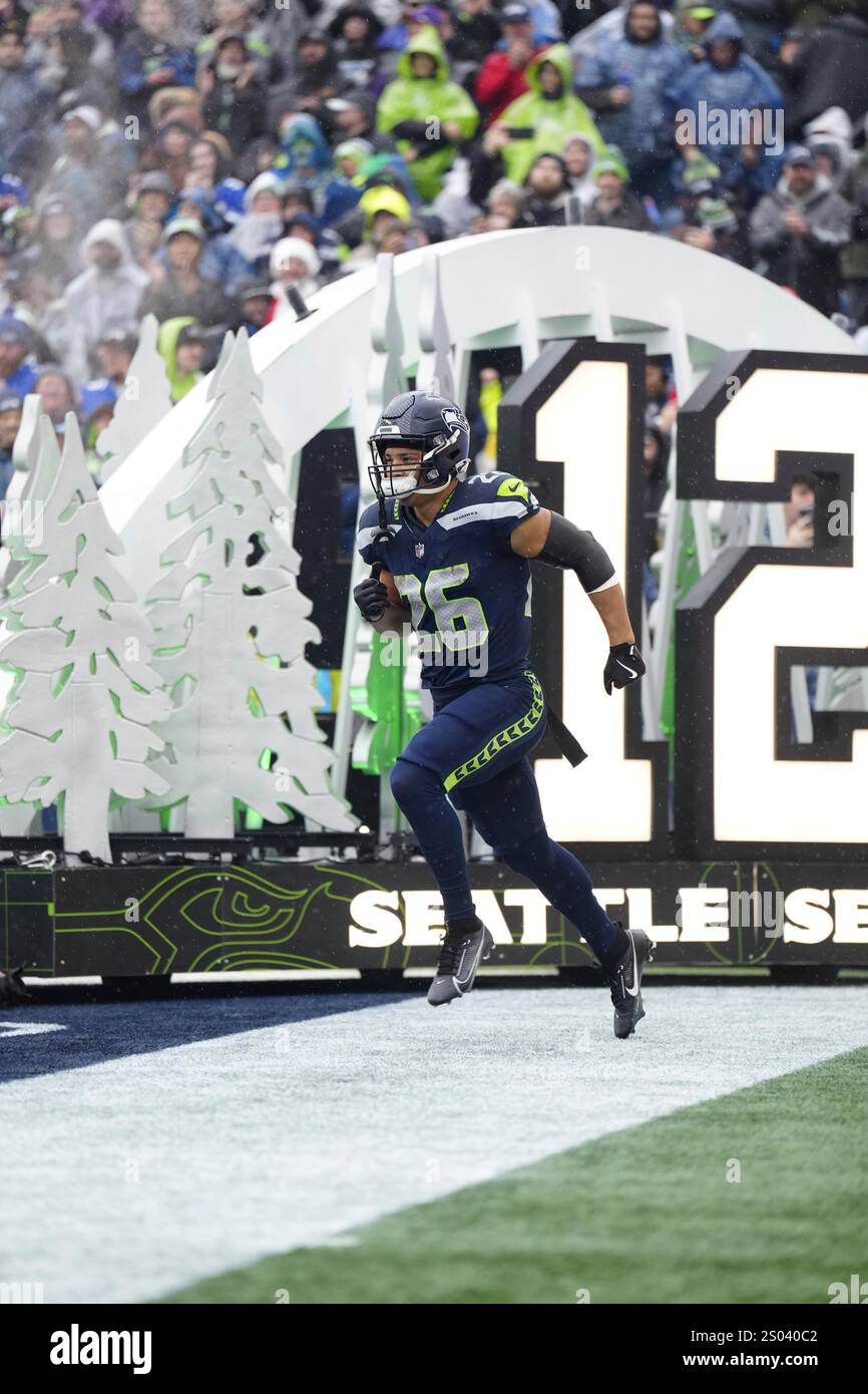 Seattle Seahawks running back Zach Charbonnet (26) runs onto the field ...