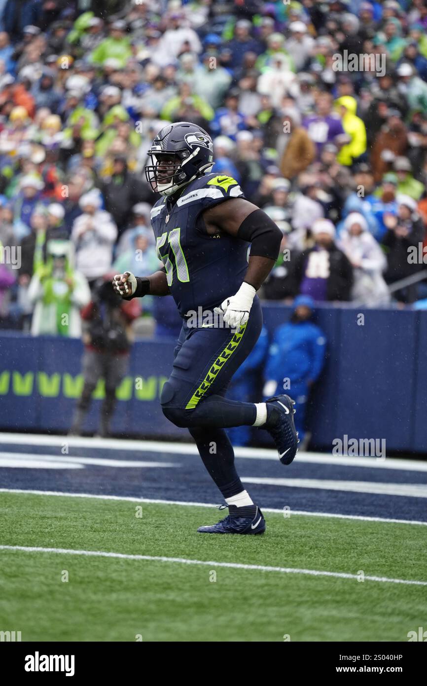 Seattle Seahawks center Olu Oluwatimi (51) runs onto the field before ...