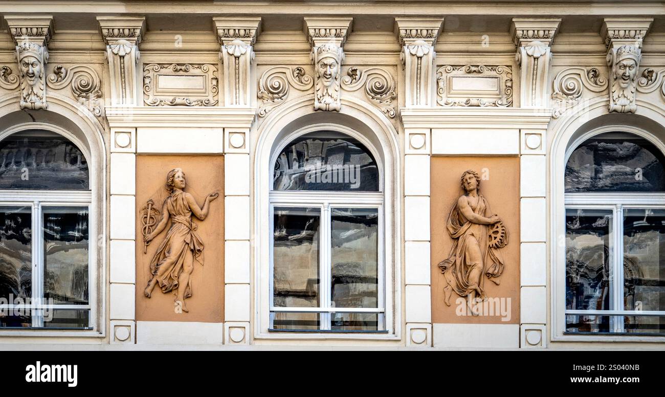 Architectural details featuring ornate relief sculptures of two figures ...