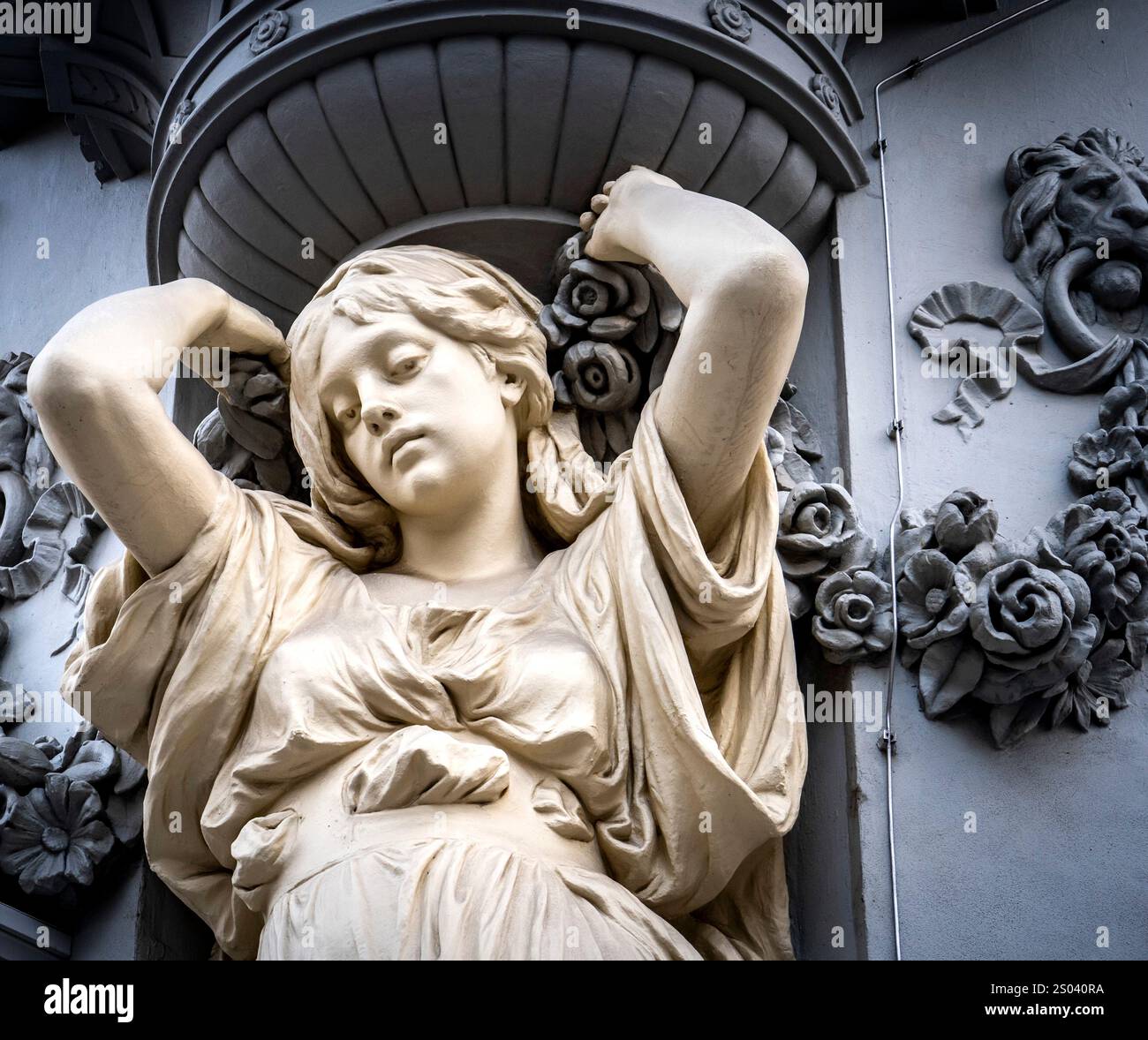 A close-up of a classical sculpture depicting a woman with a serene ...