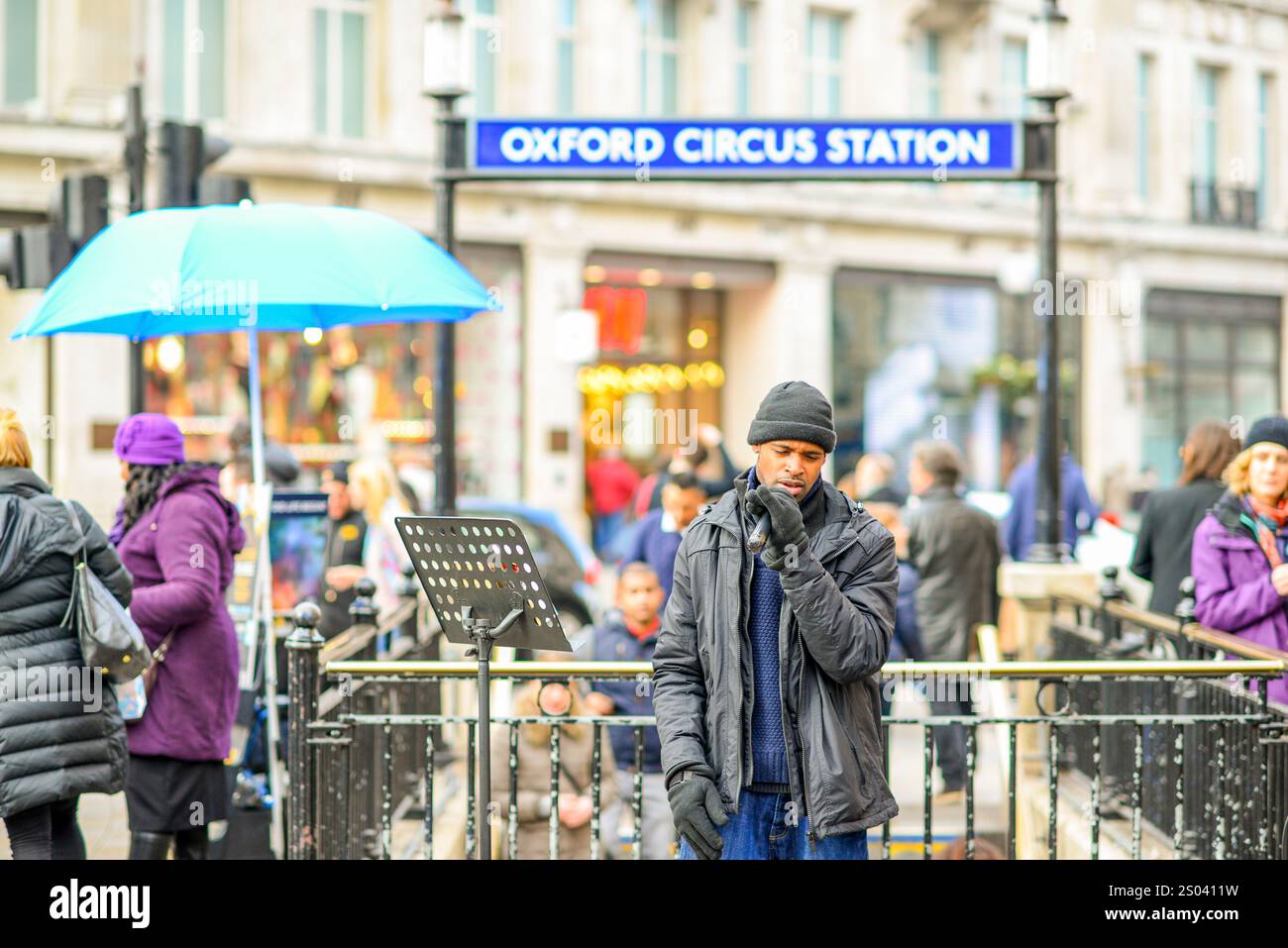 Busker outside Oxford Circus underground station, London Stock Photo ...