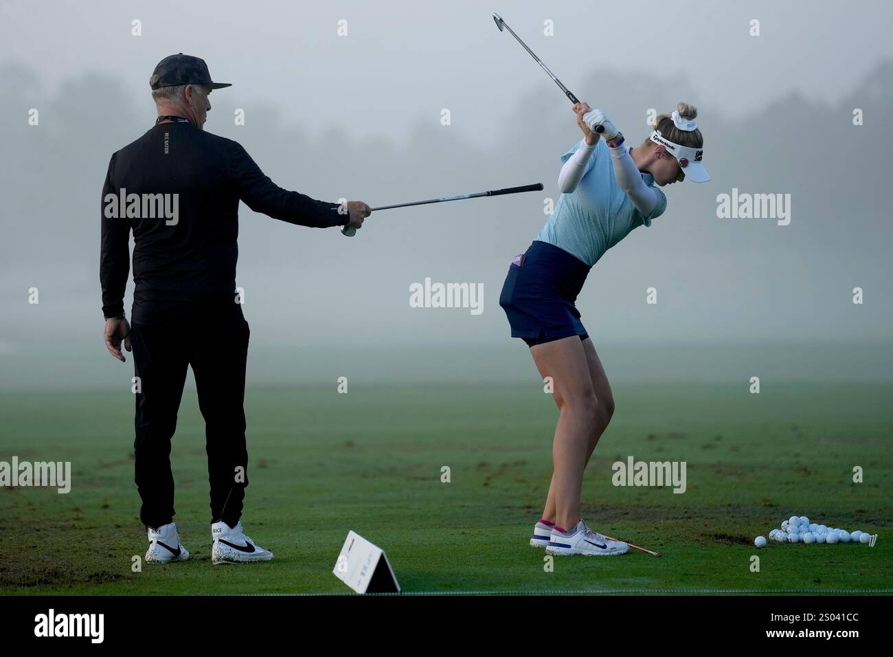 FILE - Instructor Jamie Mulligan works with Nelly Korda on the driving ...