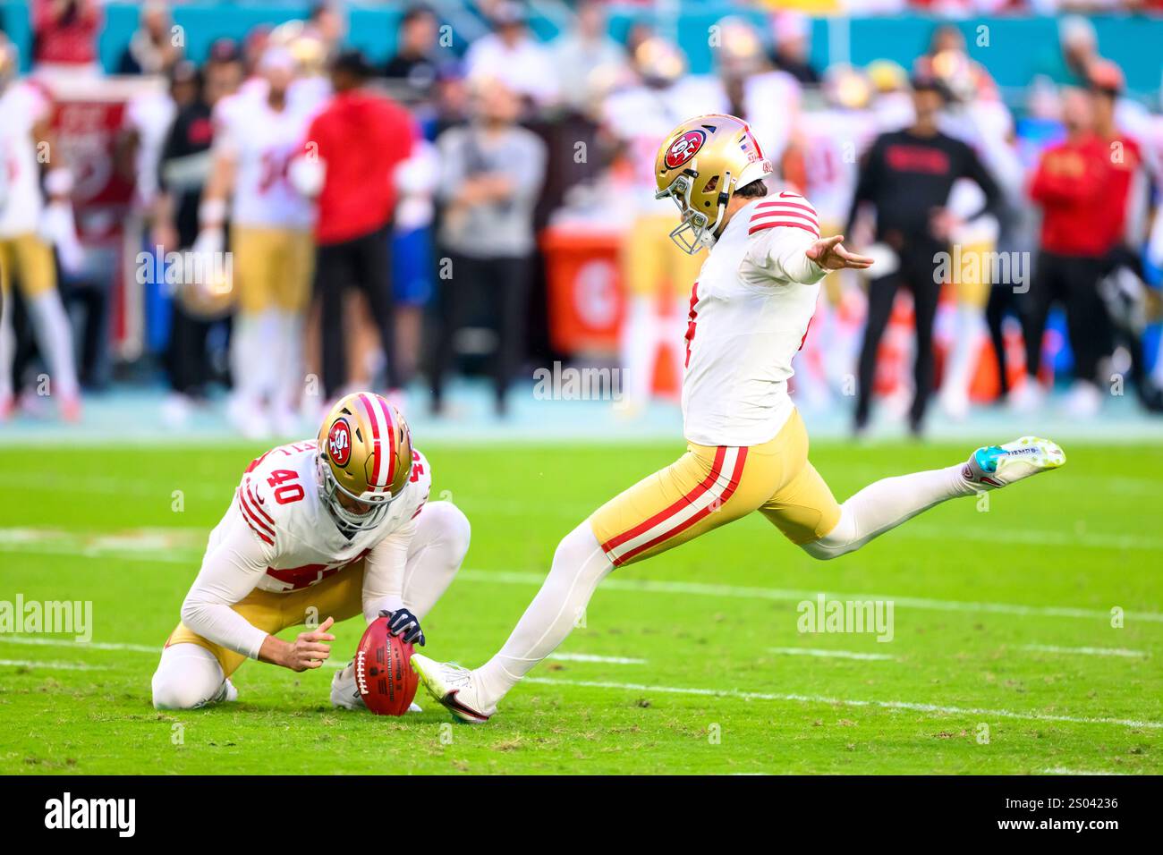San Francisco 49ers punter Pat O'Donnell (40) holds the ball as kicker ...