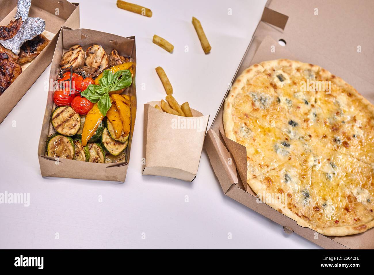 A flat lay of popular fast food items like burgers, pizza, and chicken ...