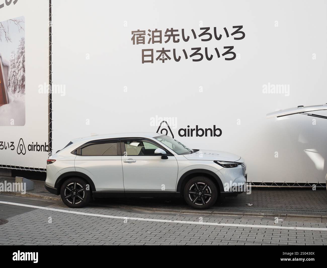 TOKYO, JAPAN - December 17, 2024: Street with billboards adverting ...